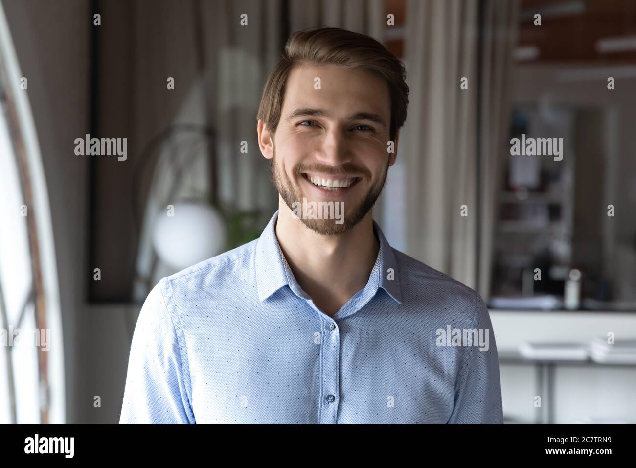 Profile picture of smiling male employee posing at workplace Stock ...