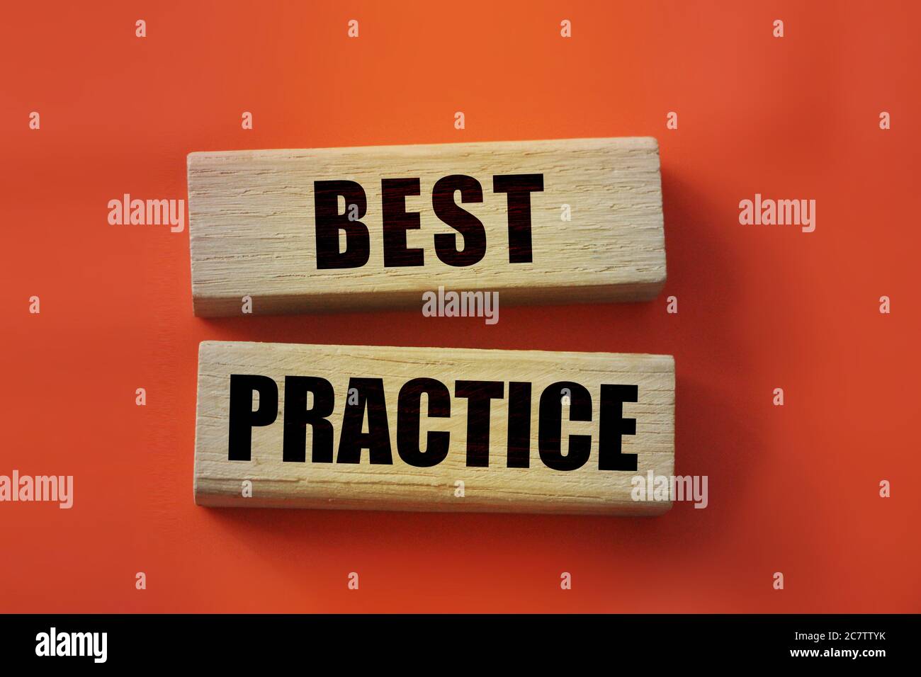 Best practice words in wooden blocks on red. Business or healthcare ...