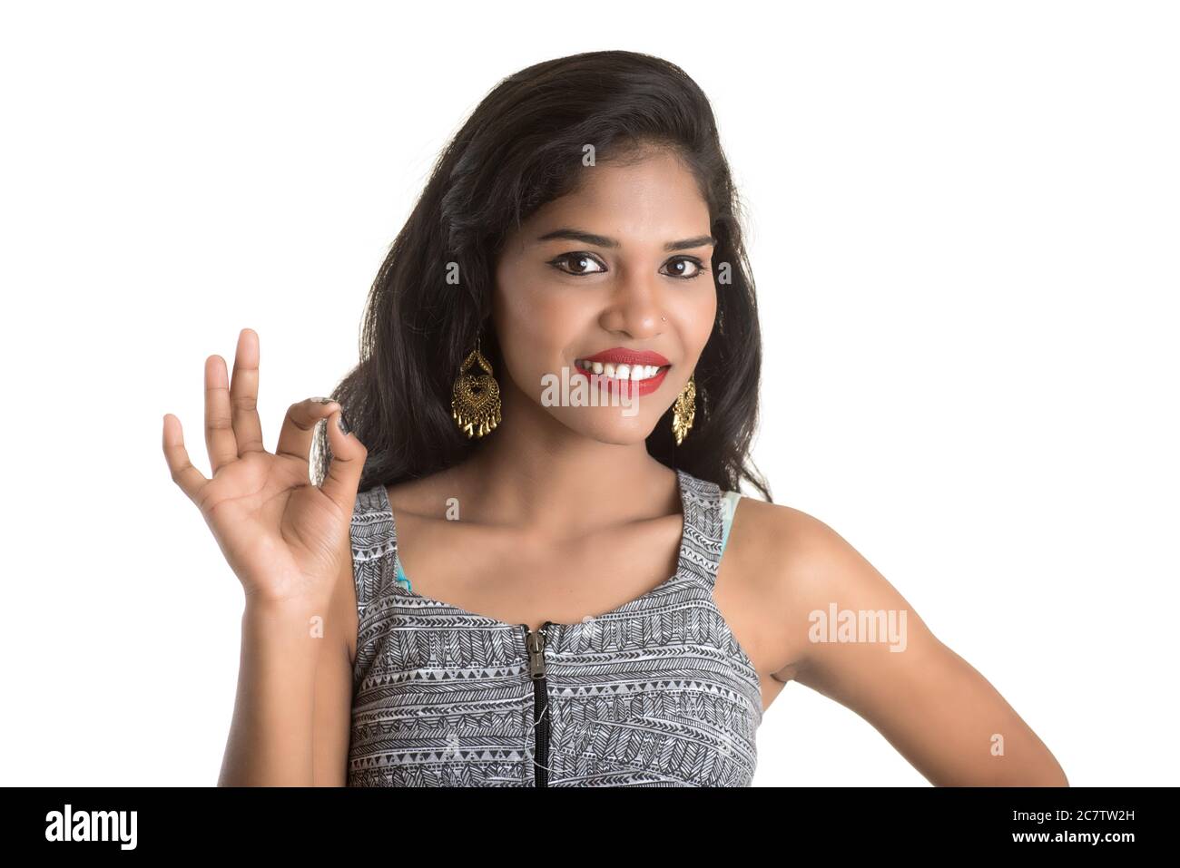Smiling cheerful girl showing sign isolated on white background Stock ...