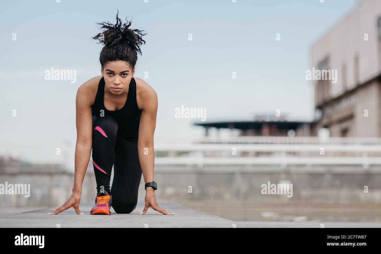 Start training or marathon. Girl in sportswear at start, is ready to ...