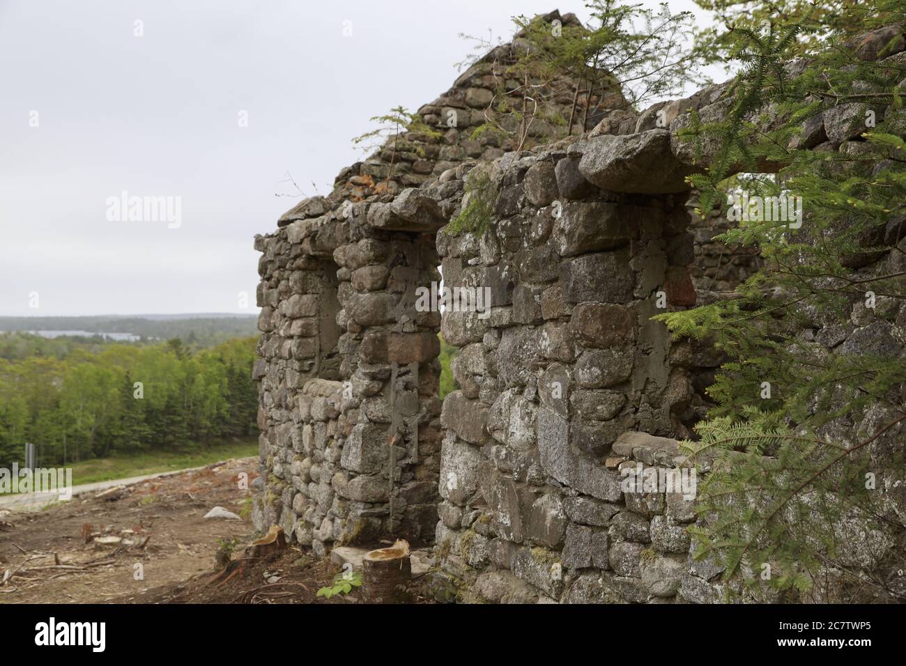 Close-up shot of old stone ruins of a forgotten lodge surrounded by ...