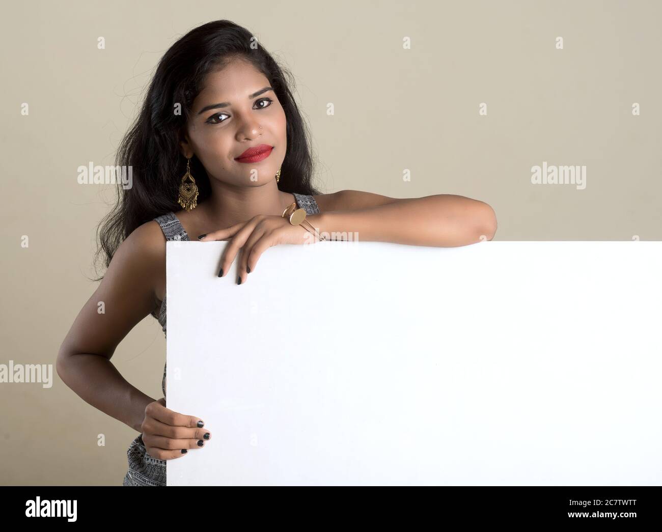 Beautiful young Girl holding white big signboard and posing Stock Photo ...