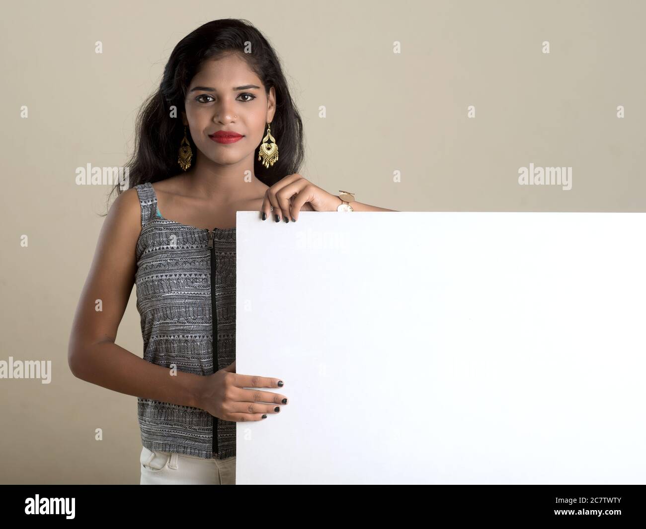 Beautiful young Girl holding white big signboard and posing Stock Photo ...