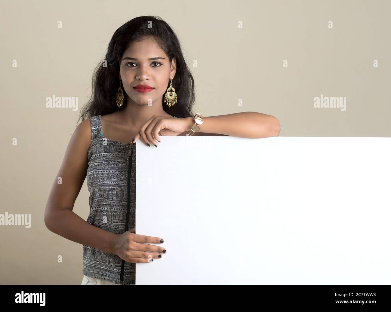 Beautiful young Girl holding white big signboard and posing Stock Photo ...