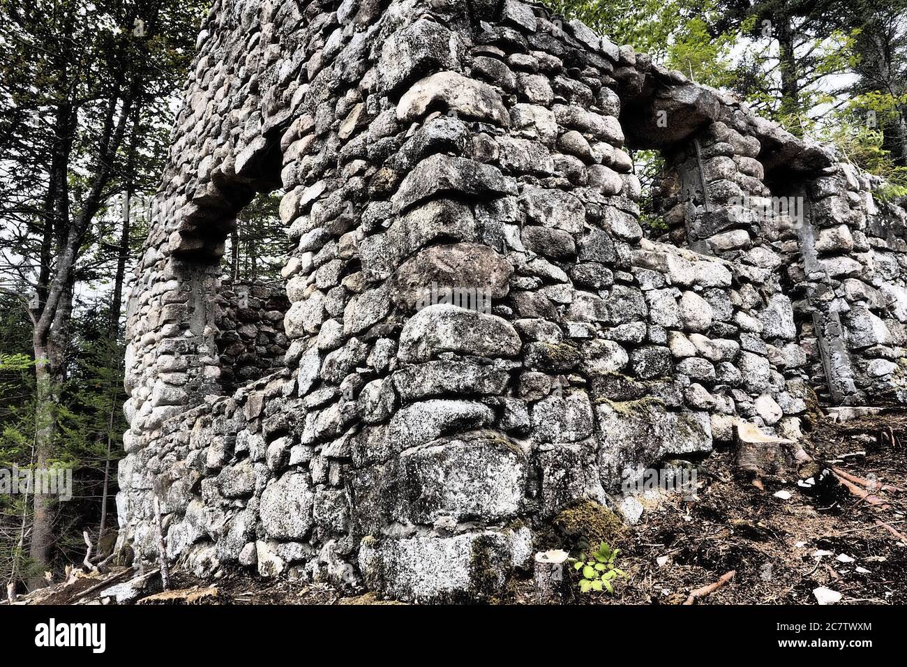 Low angle shot of 100-year-old stone ruins of a forgotten lodge ...