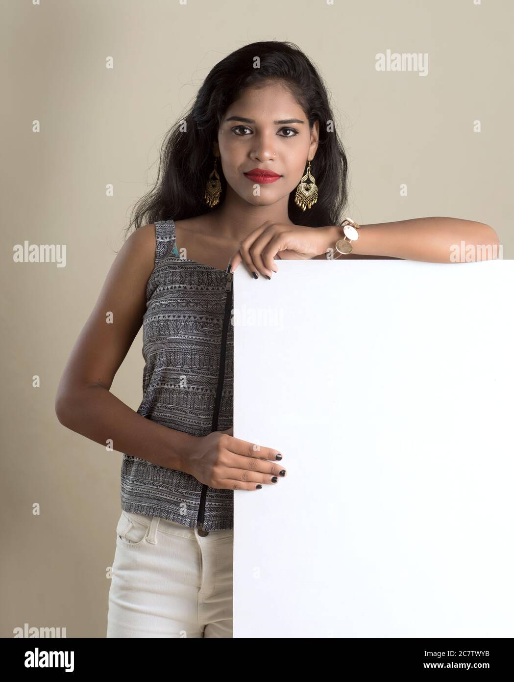 Beautiful young Girl holding white big signboard and posing Stock Photo ...