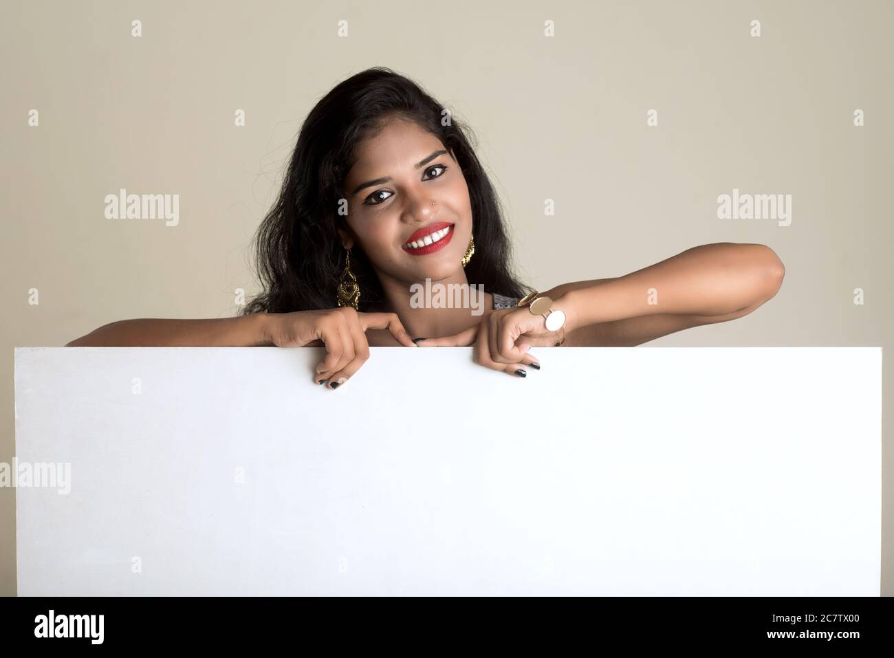 Beautiful young Girl holding white big signboard and posing Stock Photo ...