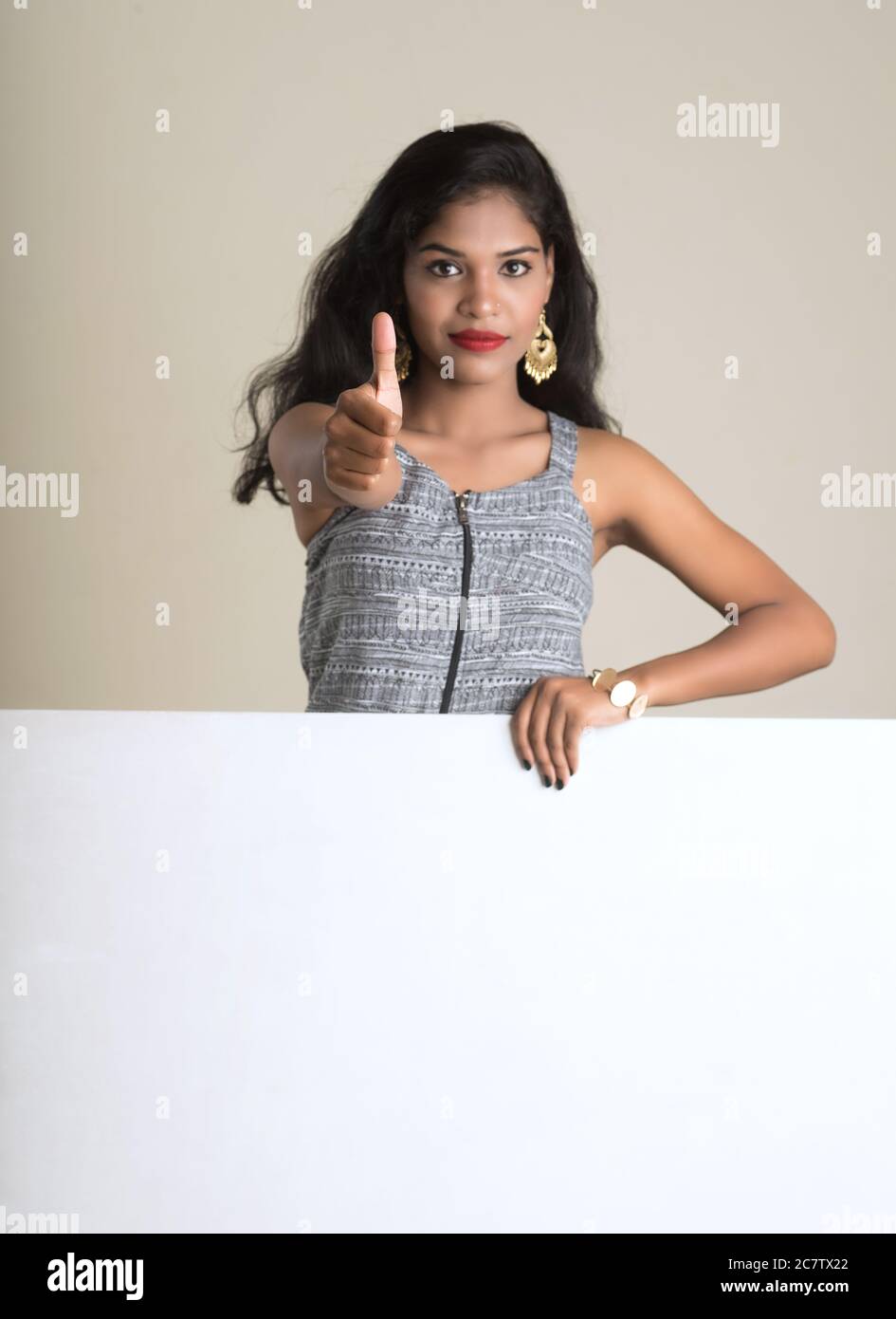 Beautiful young Girl holding white big signboard and posing Stock Photo ...