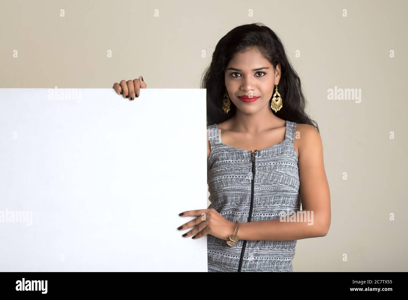 Beautiful young Girl holding white big signboard and posing Stock Photo ...