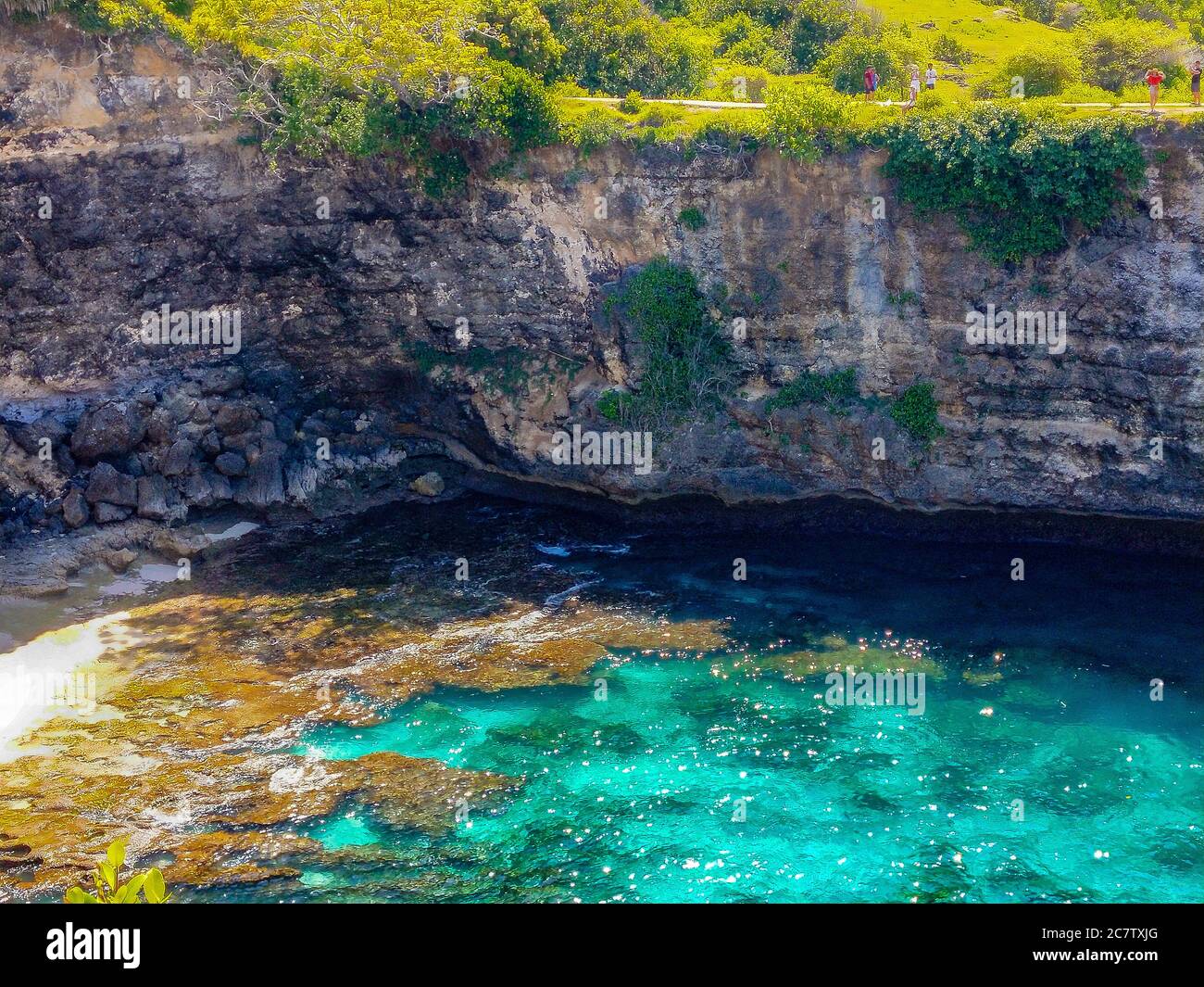 Rock coastline. Stone arch over the sea. Broken beach, Nusa Penida ...