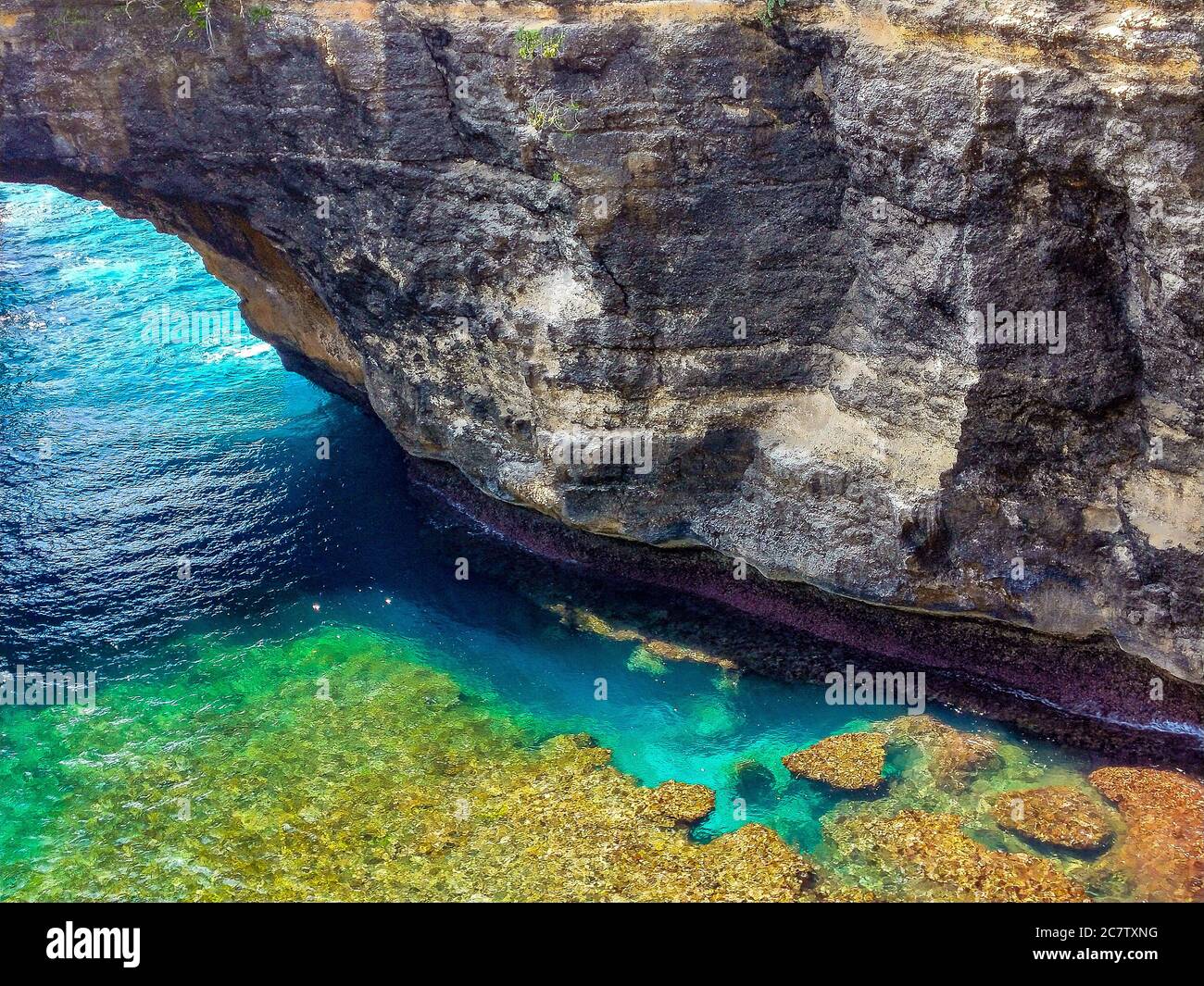 Rock coastline. Stone arch over the sea. Broken beach, Nusa Penida ...