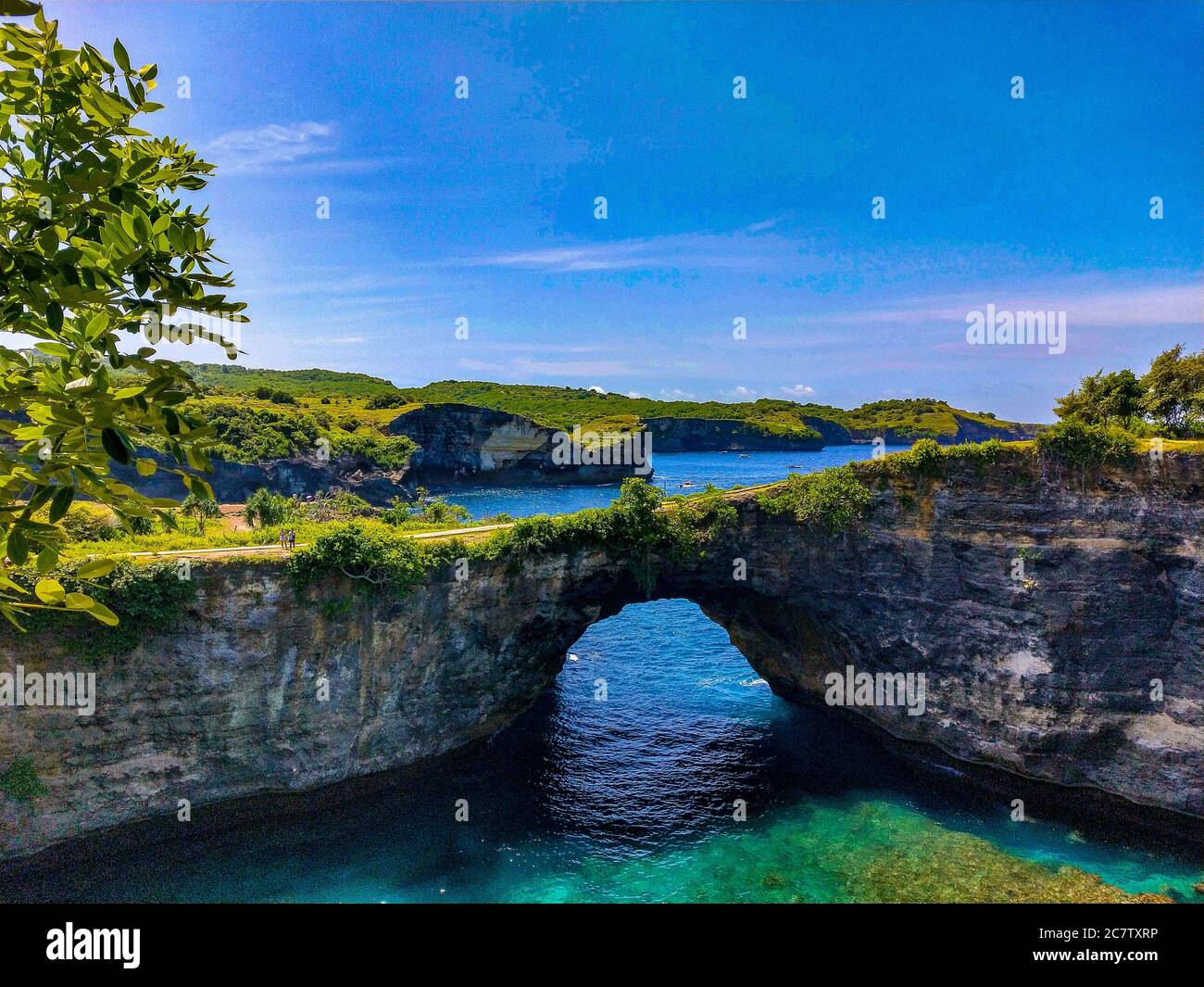 Rock coastline. Stone arch over the sea. Broken beach, Nusa Penida ...