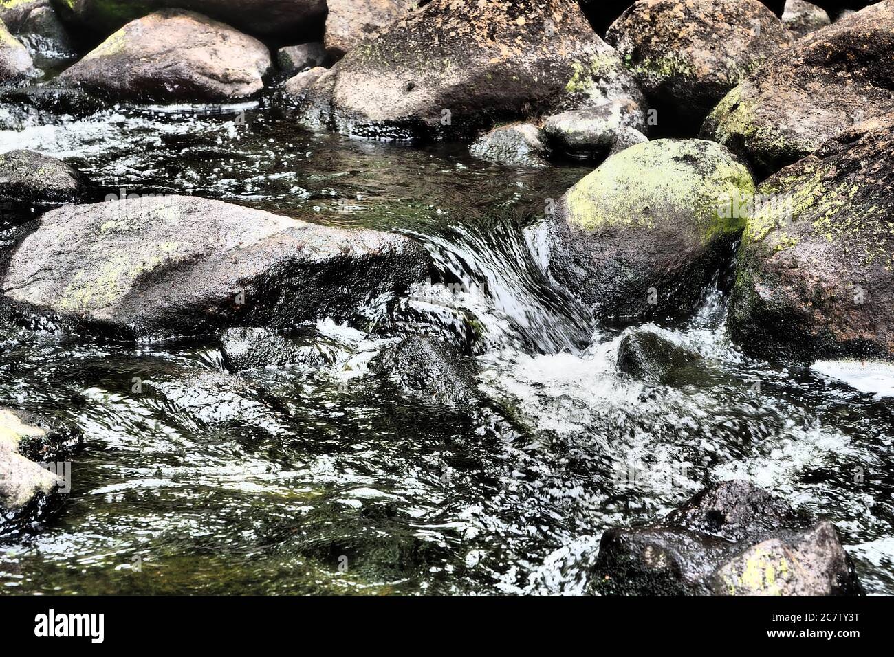 Waterfall falling into a lake with stones covered with moss in Halifax ...