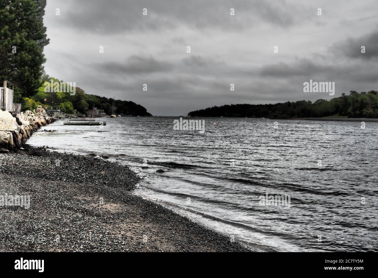 Lakeshore with pebbles and a dark sky over it in Halifax, Canada Stock ...