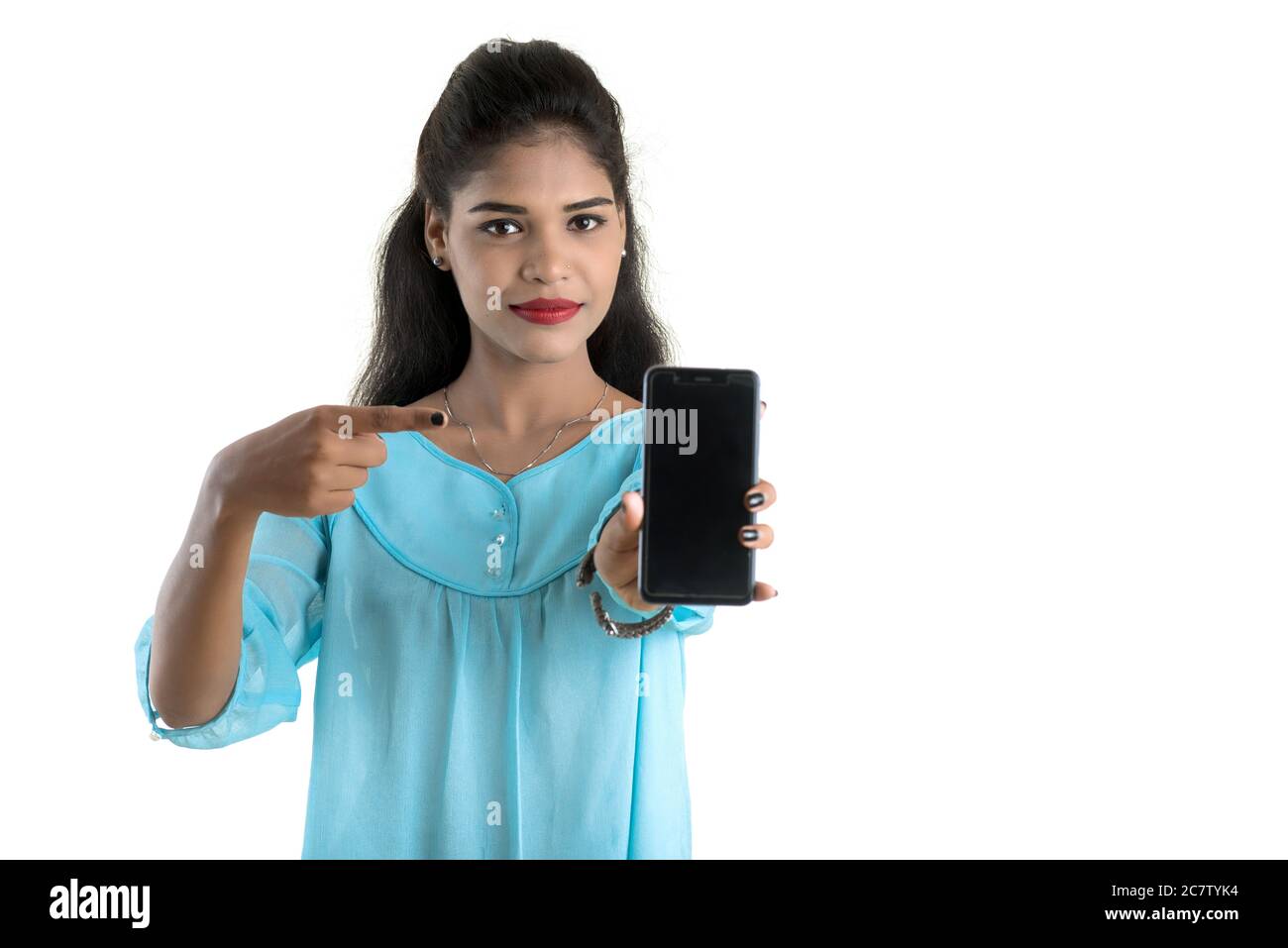 Young Indian girl using a mobile phone or smartphone isolated on a ...