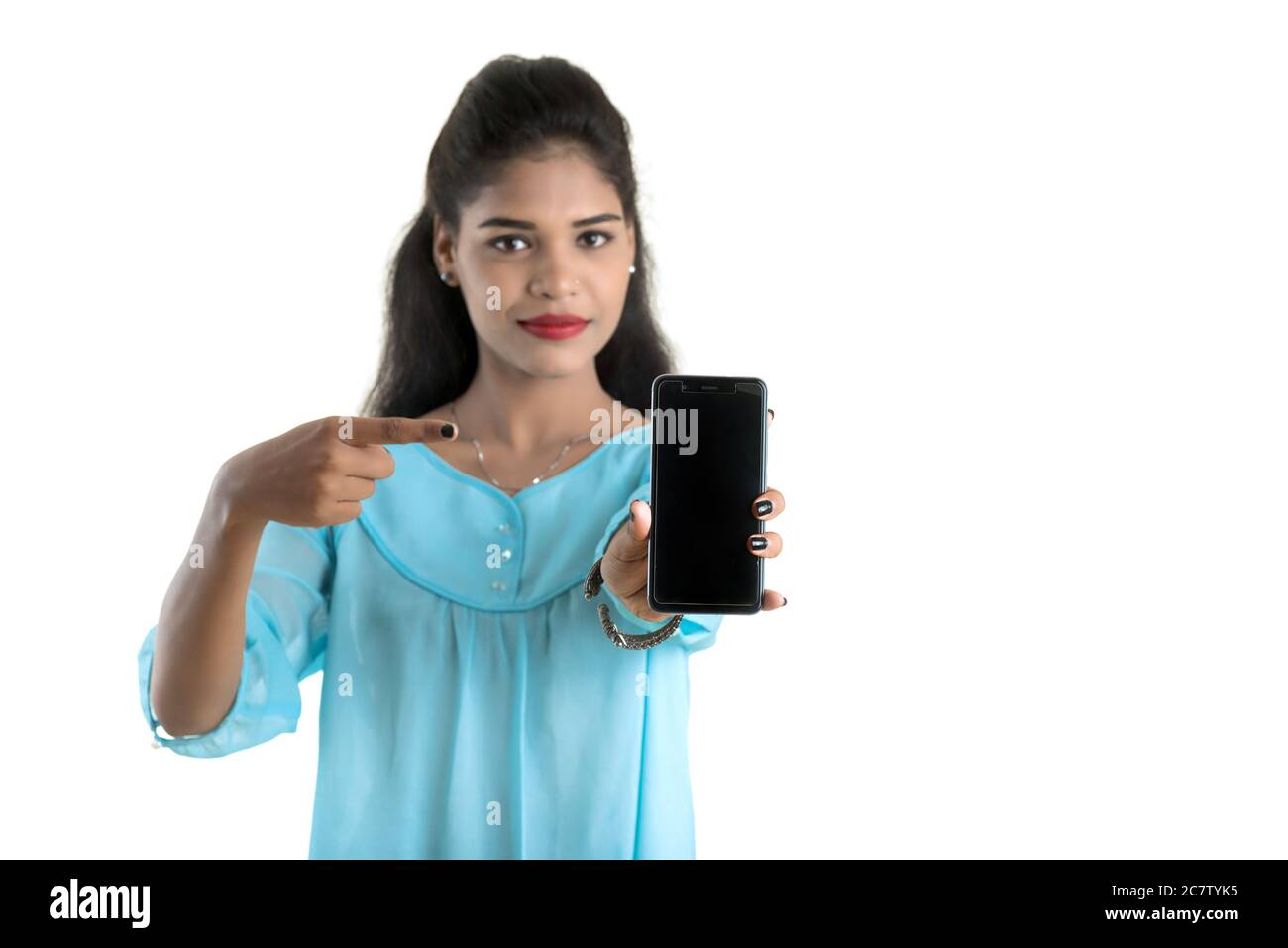 Young Indian girl using a mobile phone or smartphone isolated on a ...
