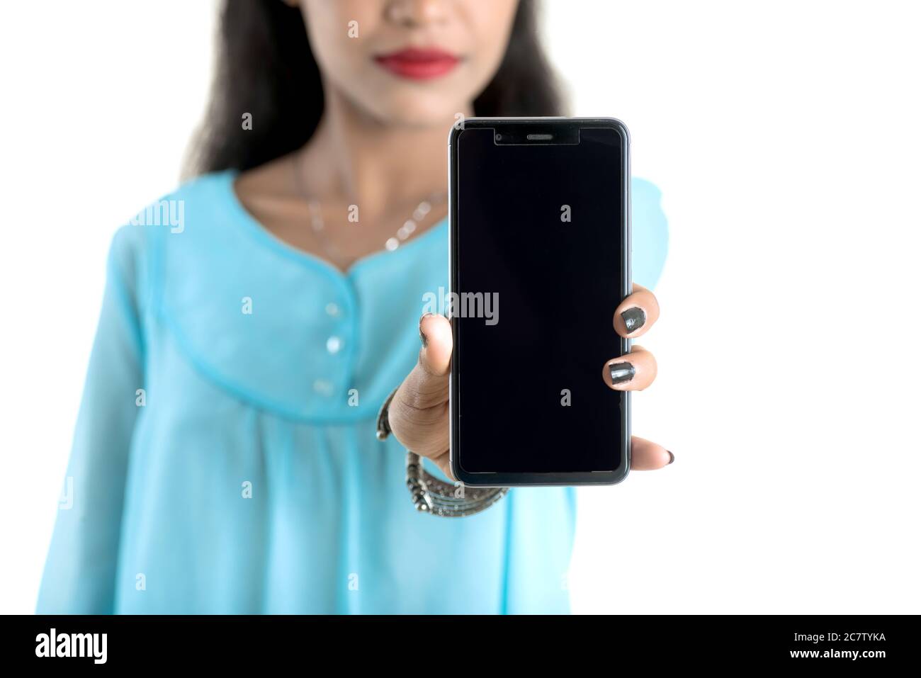 Young Indian girl using a mobile phone or smartphone isolated on a ...