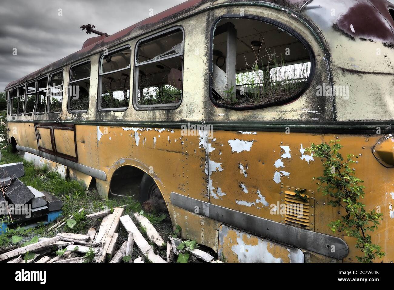 Closeup side view of an old abandoned wrecked bus full of rubbish Stock ...