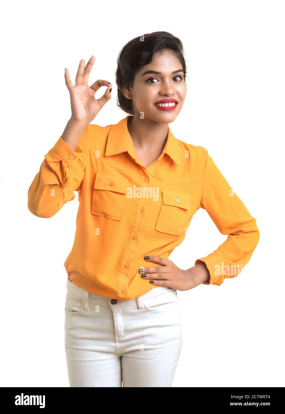 Smiling cheerful girl showing sign isolated on white background Stock ...