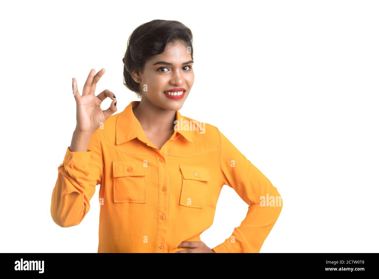 Smiling cheerful girl showing sign isolated on white background Stock ...