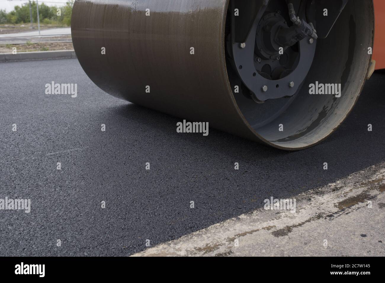 Closeup of a road-roller on the fresh asphalt at daytime Stock Photo ...