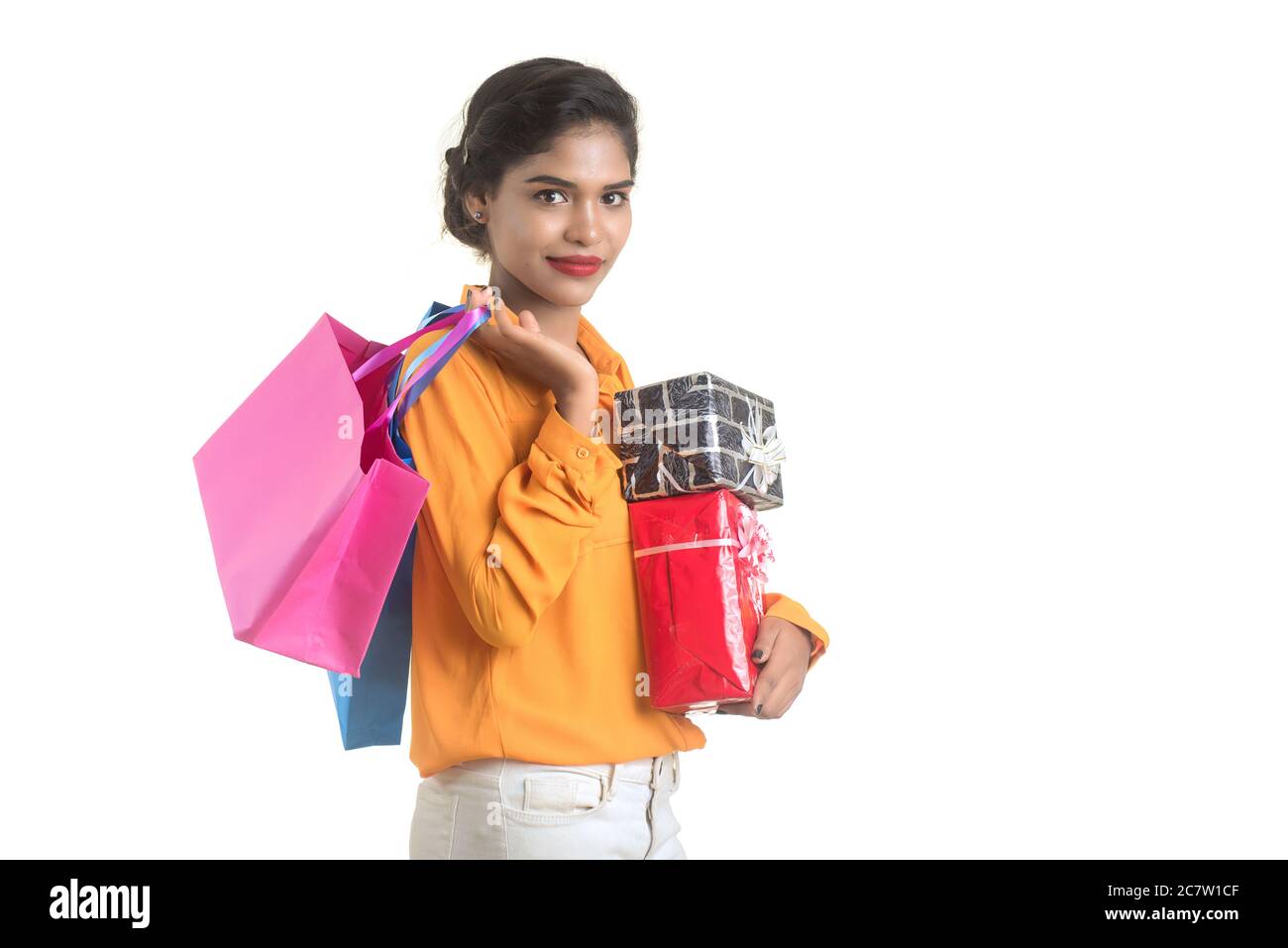 Beautiful woman carrying many shopping bags and gift Box on a white ...