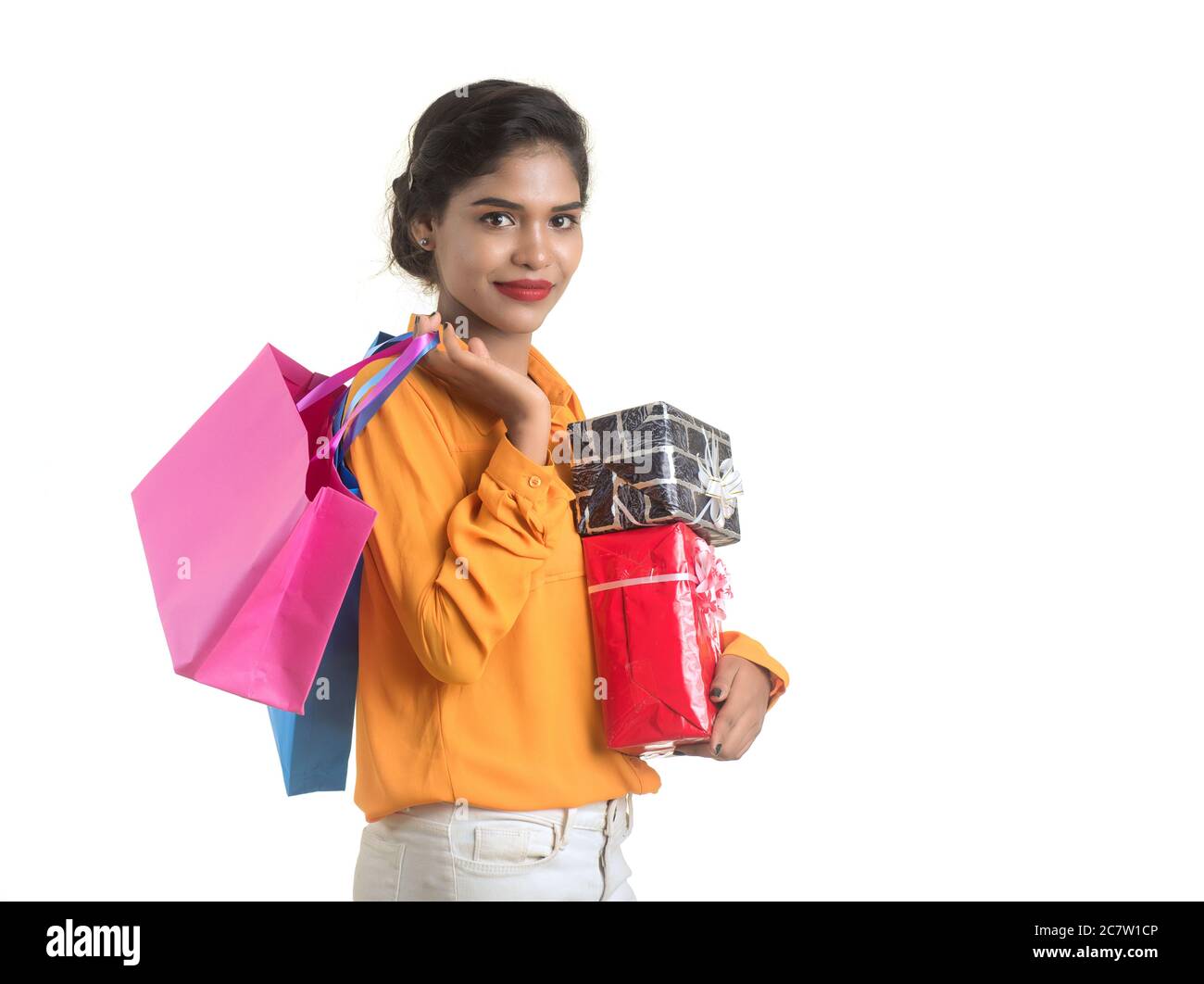 Beautiful woman carrying many shopping bags and gift Box on a white ...