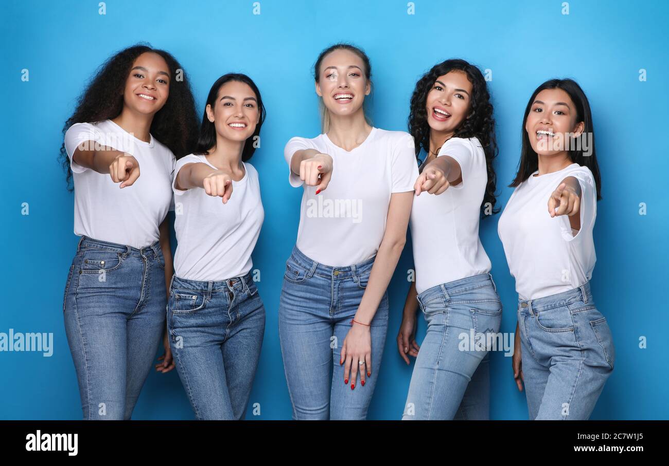 Multiethnic Girls Pointing Finger At Camera Over Blue Background ...