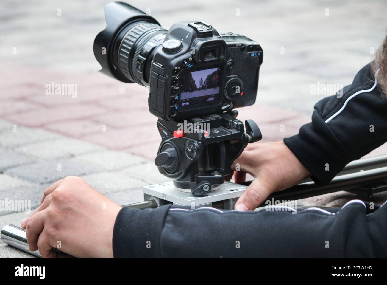 The camera in the hands of photographer Stock Photo - Alamy