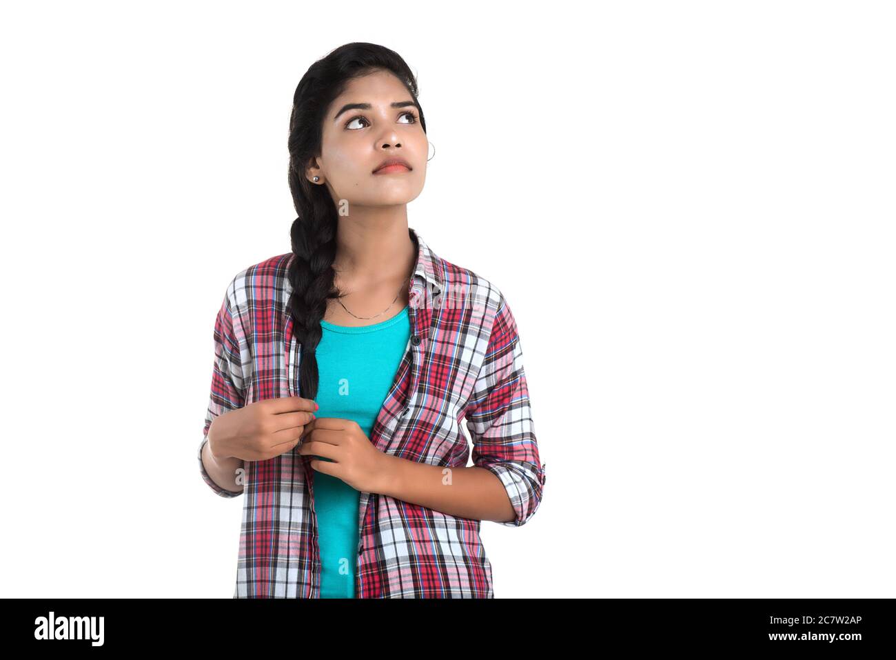 Indian girl thinking on a white background Stock Photo - Alamy