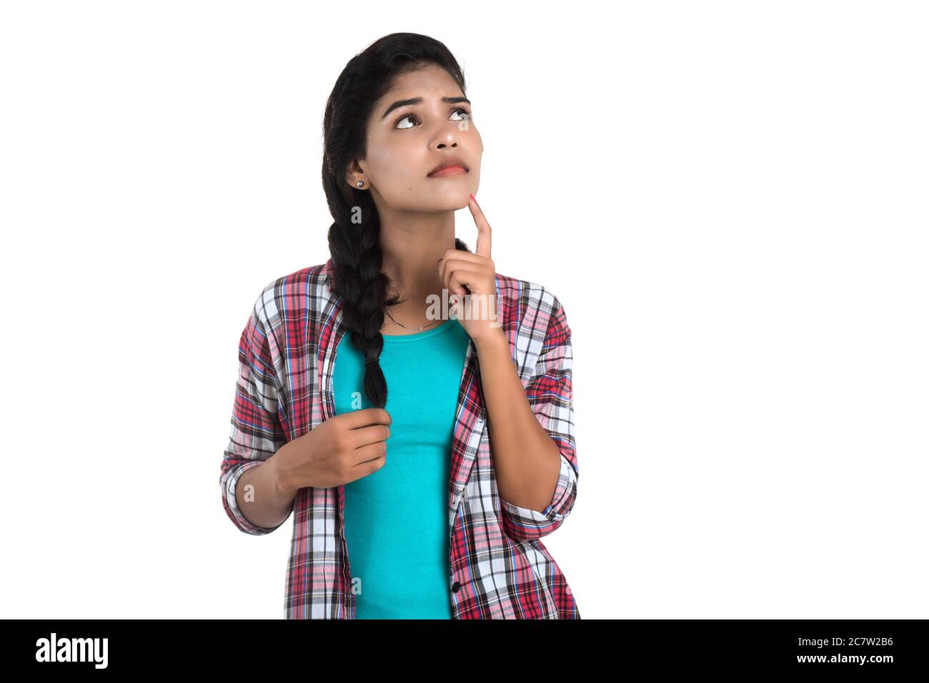 Indian girl thinking on a white background Stock Photo - Alamy