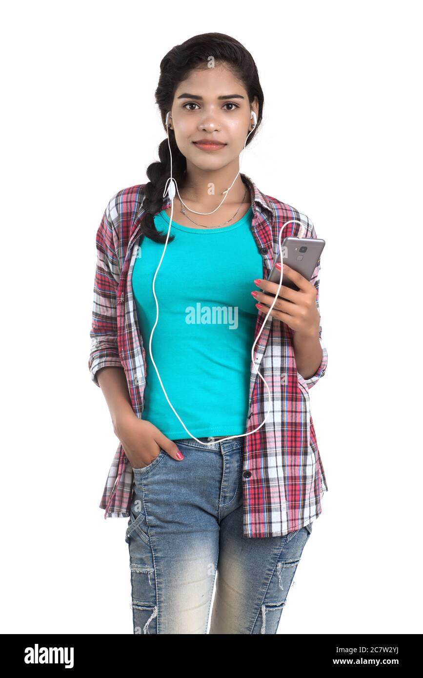 Young Indian girl using a mobile phone or smartphone isolated on a ...