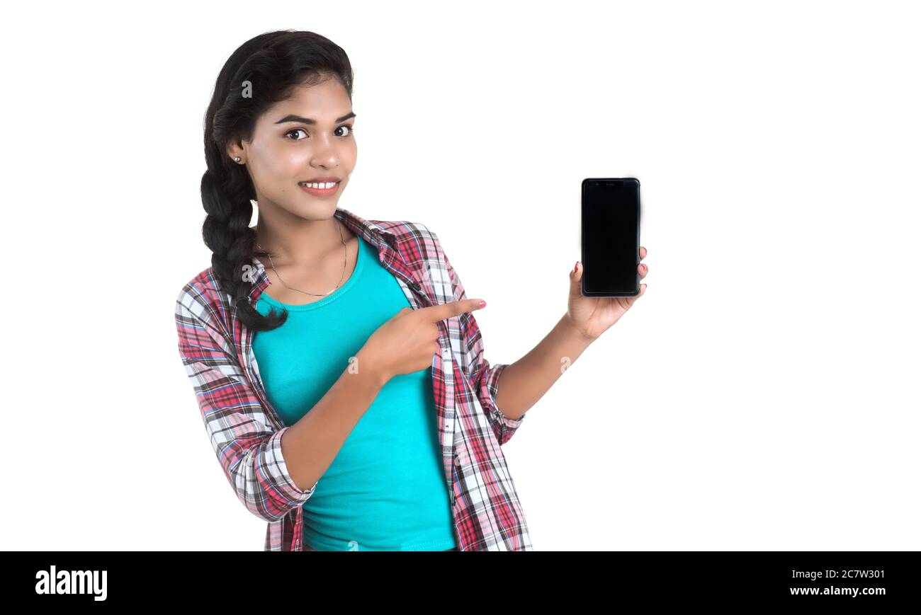 Young Indian girl using a mobile phone or smartphone isolated on a ...