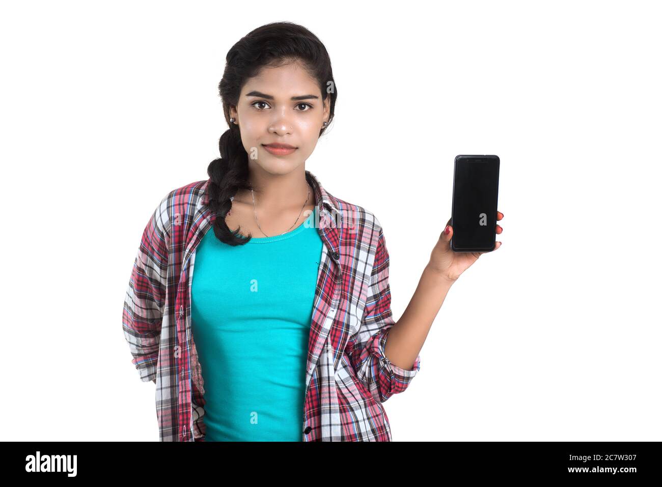 Young Indian girl using a mobile phone or smartphone isolated on a ...