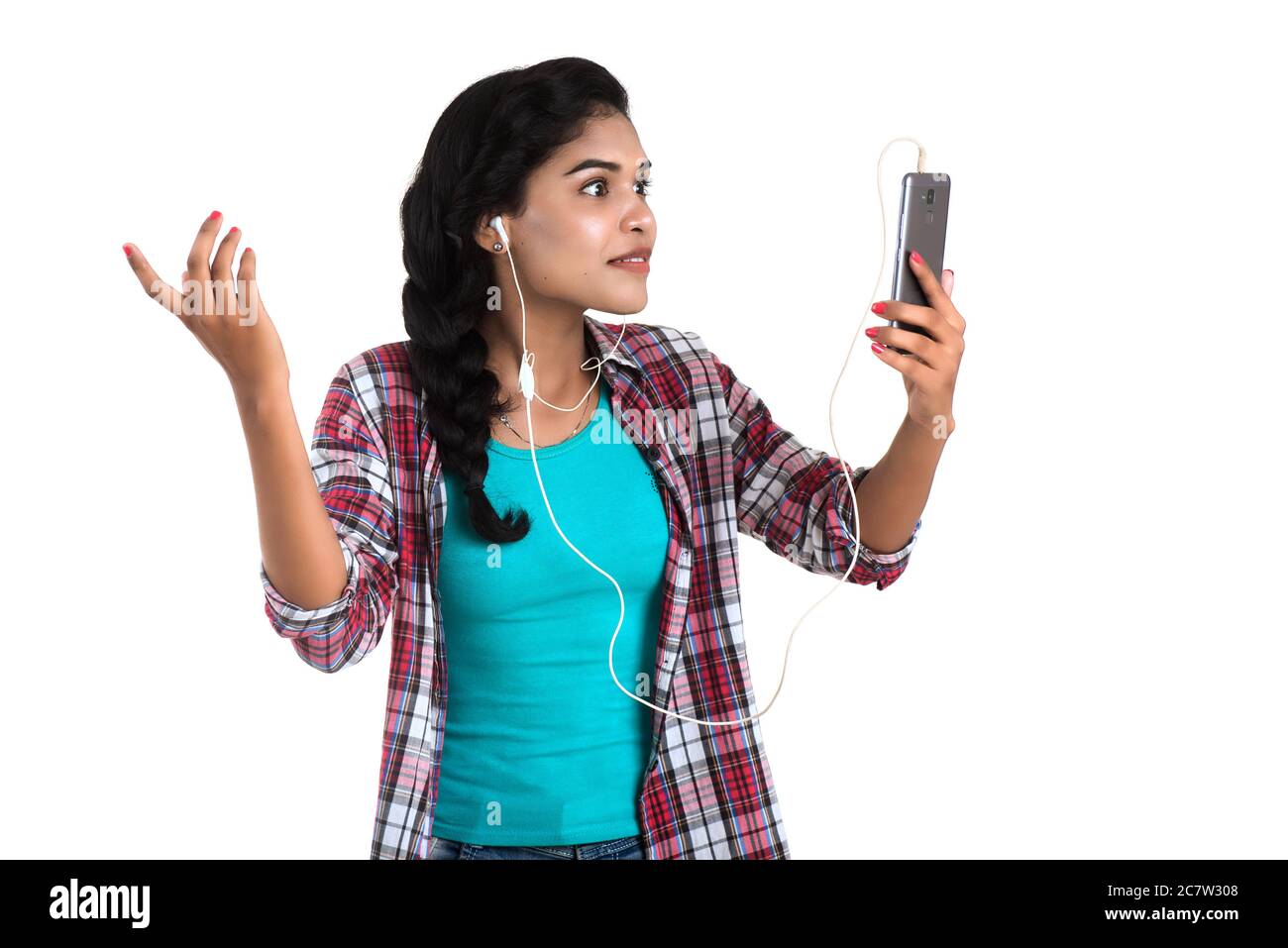 Young Indian girl using a mobile phone or smartphone isolated on a ...