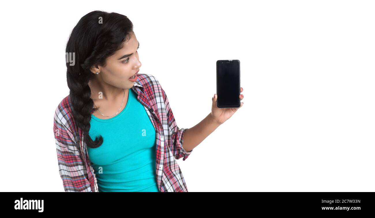 Young Indian girl using a mobile phone or smartphone isolated on a ...