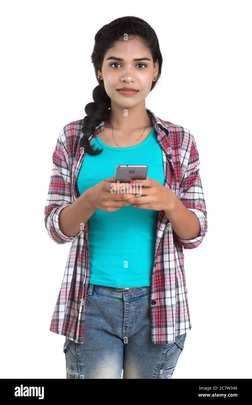 Young Indian girl using a mobile phone or smartphone isolated on a ...