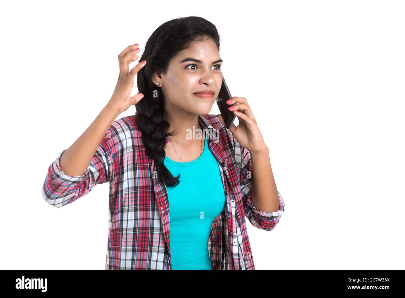 Young Indian girl using a mobile phone or smartphone isolated on a ...