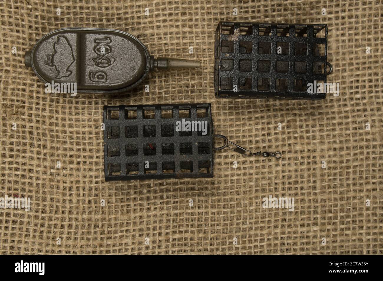 Fishing troughs and fish bait on burlap background. Set of fish feeders ...