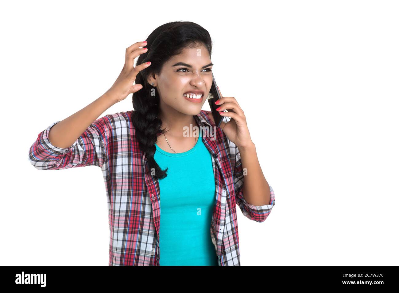 Young Indian girl using a mobile phone or smartphone isolated on a ...