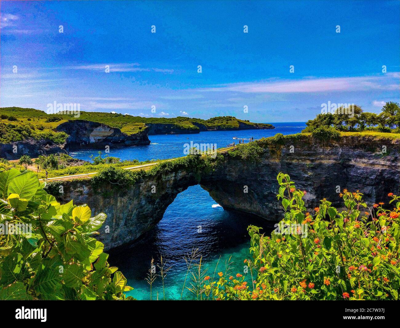 Rock coastline. Stone arch over the sea. Broken beach, Nusa Penida ...
