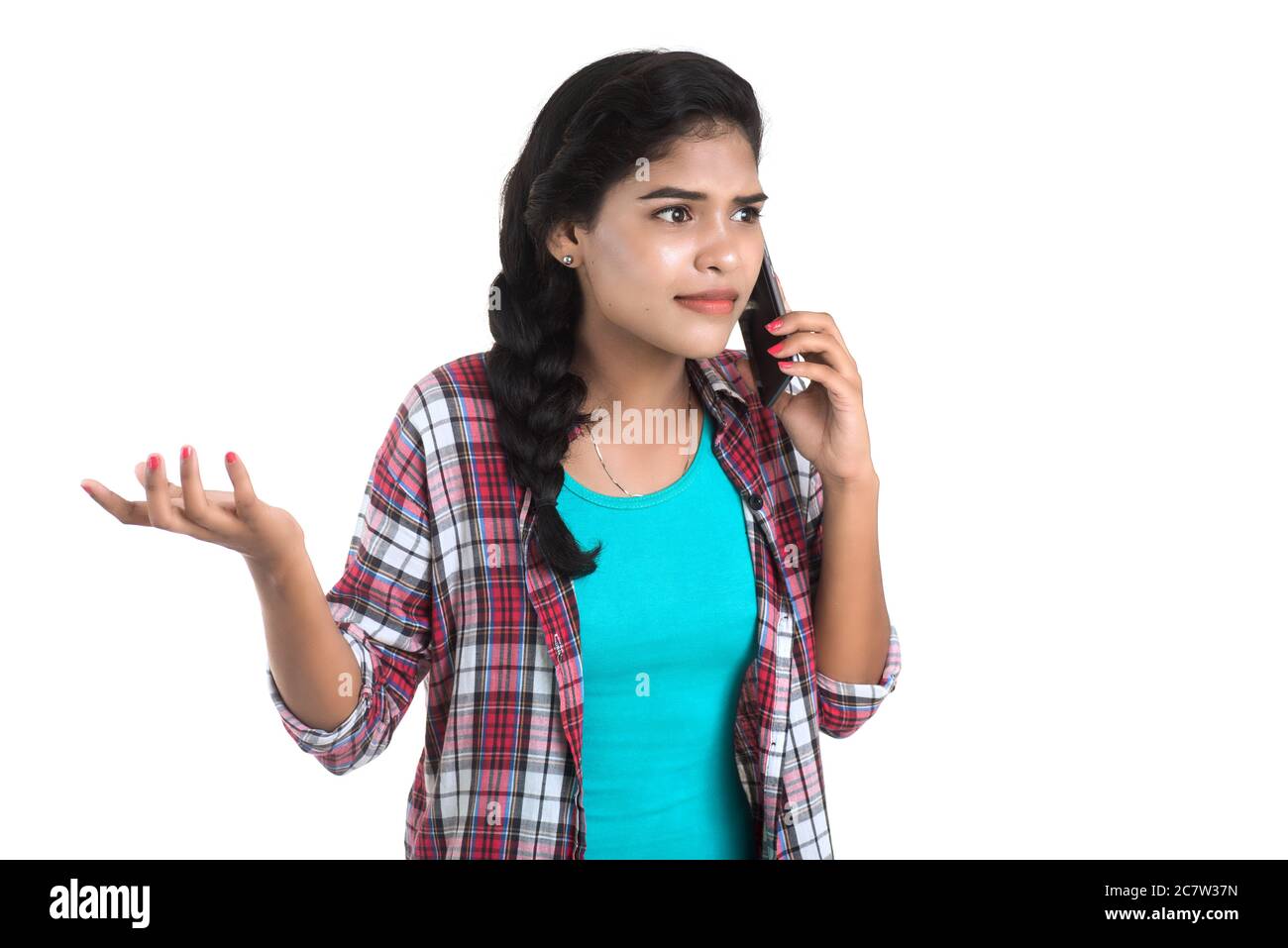 Young Indian girl using a mobile phone or smartphone isolated on a ...