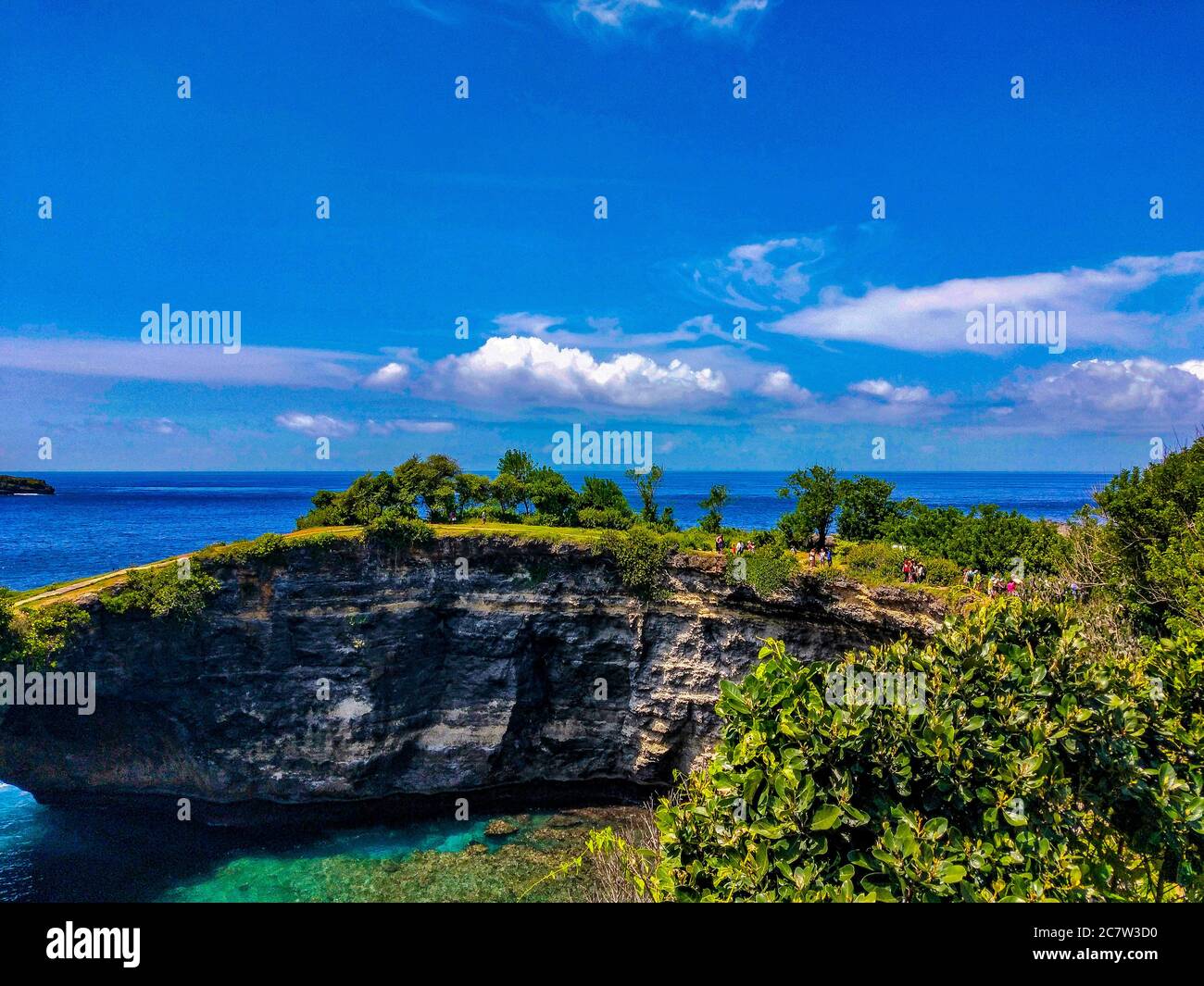 Rock coastline. Stone arch over the sea. Broken beach, Nusa Penida ...