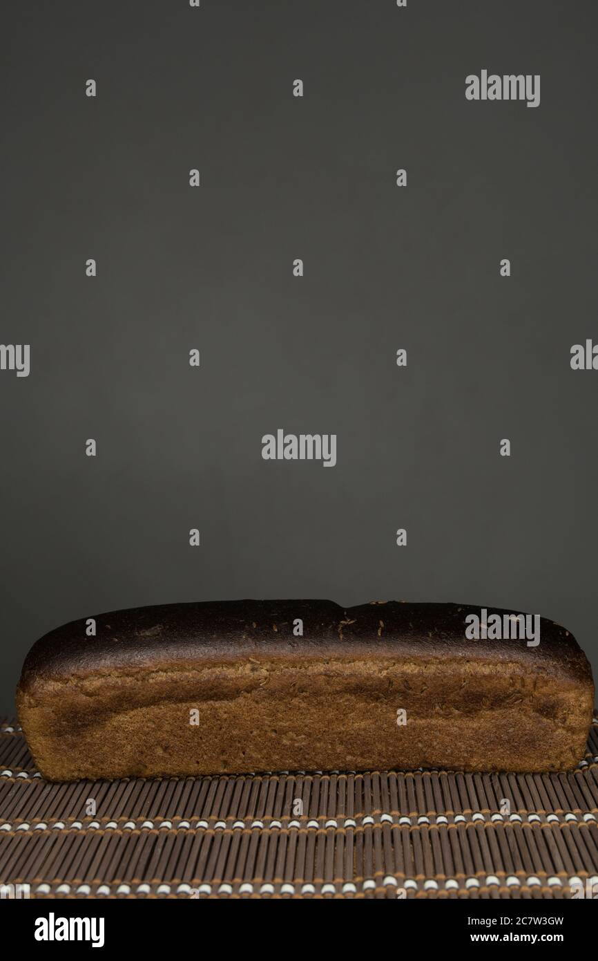 Black whole bread on a mirror background Stock Photo - Alamy