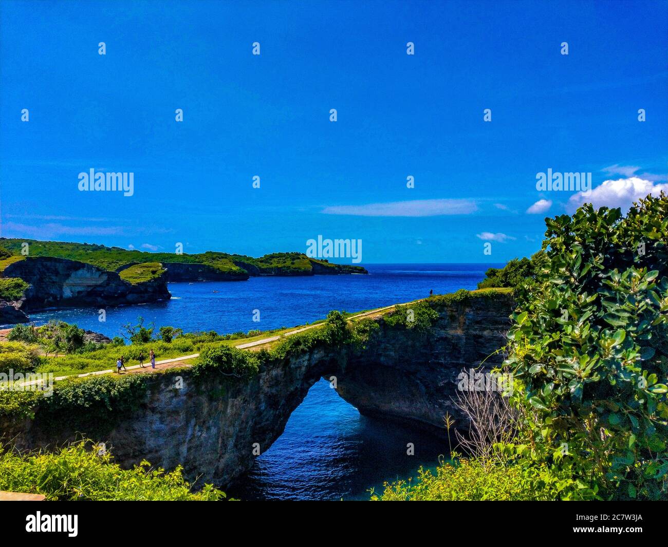 Rock coastline. Stone arch over the sea. Broken beach, Nusa Penida ...
