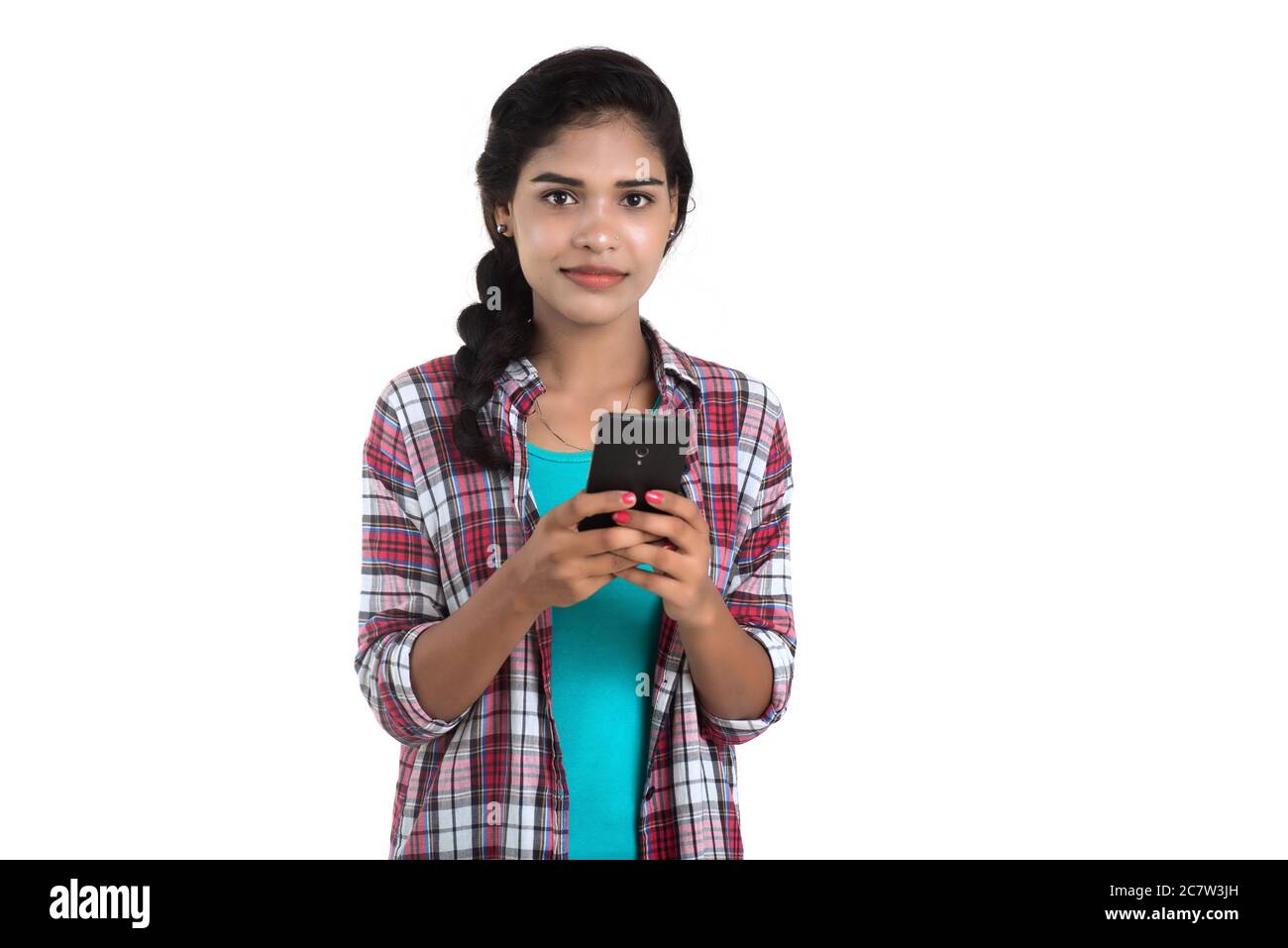 Young Indian girl using a mobile phone or smartphone isolated on a ...