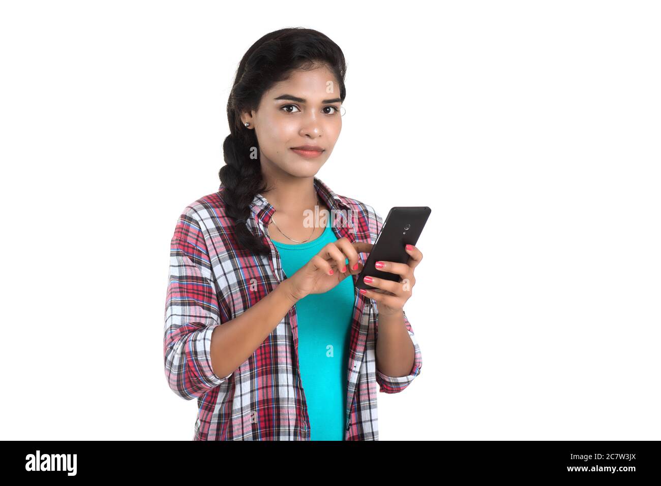 Young Indian girl using a mobile phone or smartphone isolated on a ...