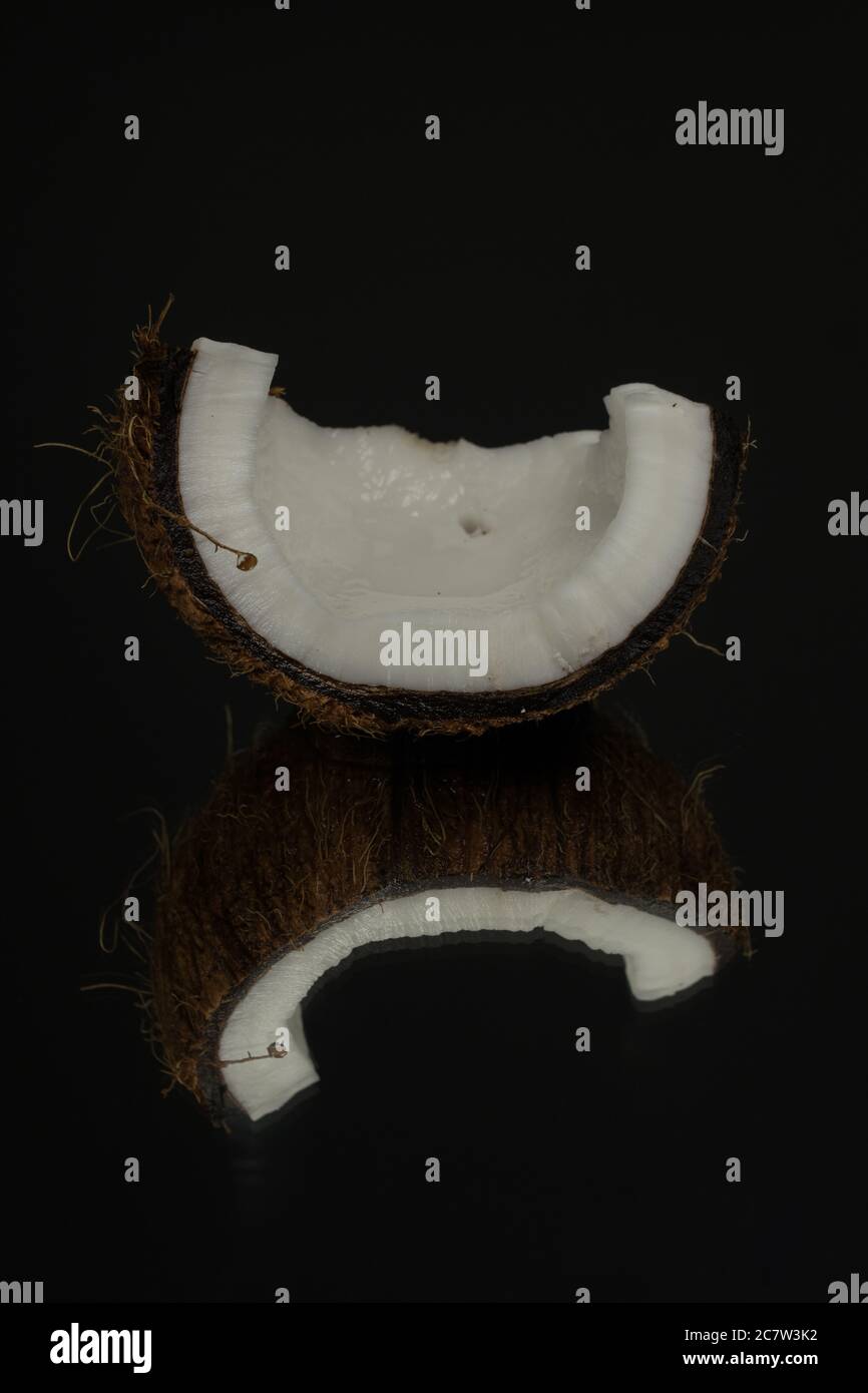 Coconut on a black background. Dark background Stock Photo - Alamy