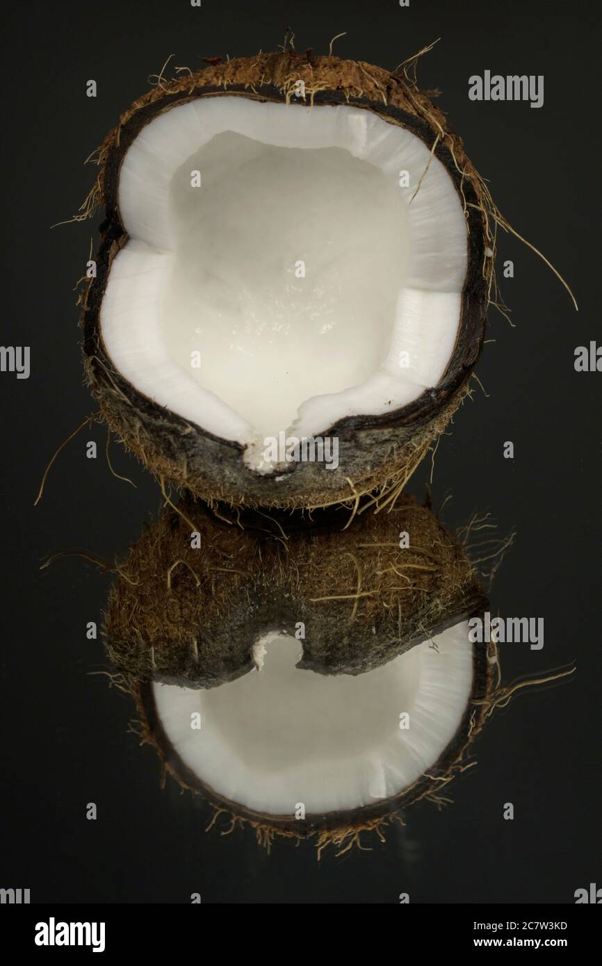 Coconut on a black background. Dark background Stock Photo - Alamy