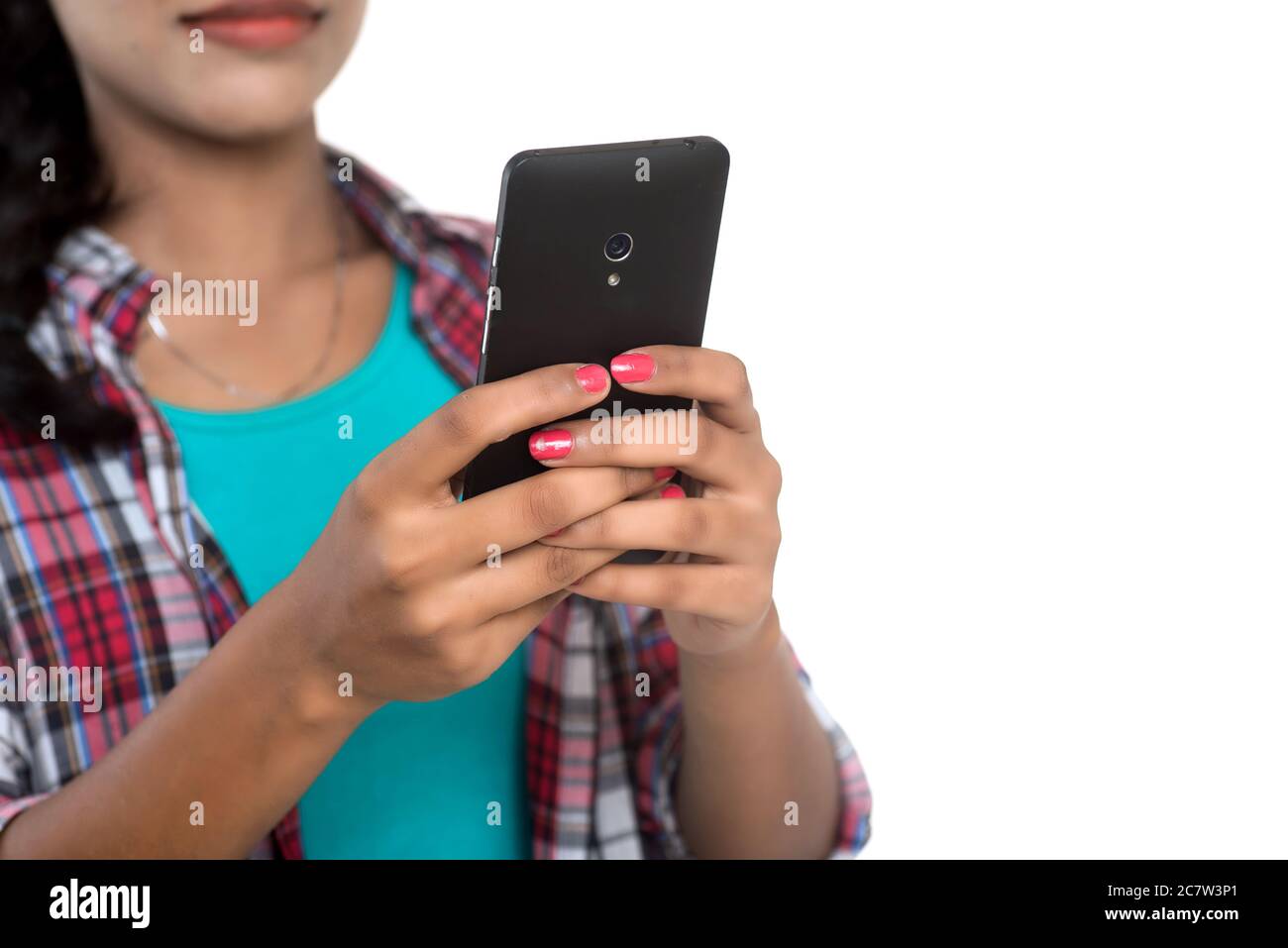 Young Indian girl using a mobile phone or smartphone isolated on a ...